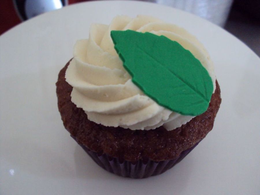 A Single Simple Carrot Cake Cupcake With Creamcheesebuttercream Frosting And Fondant Leaf ...